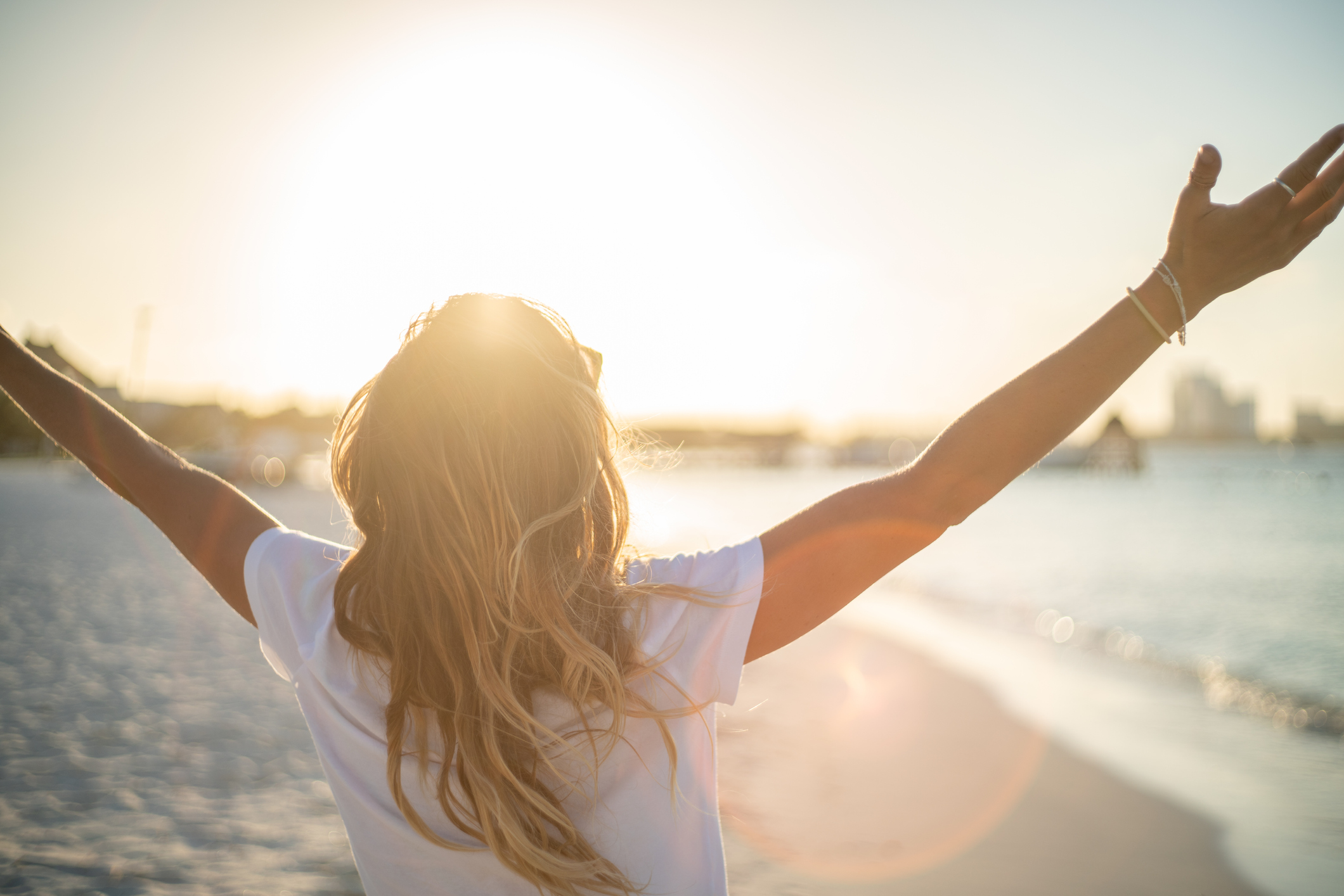 Cheerful young woman embracing nature at sunset; female standing… – The ...